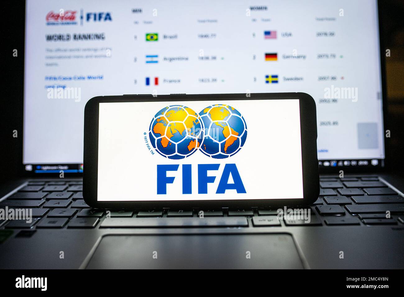 In this photo illustration a FIFA logo seen displayed on a smartphone ...