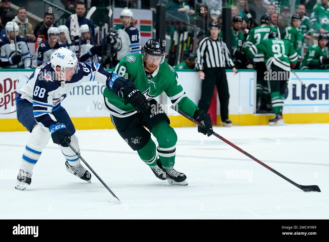 Winnipeg Jets defenseman Nate Schmidt (88) challenges Dallas Stars left ...