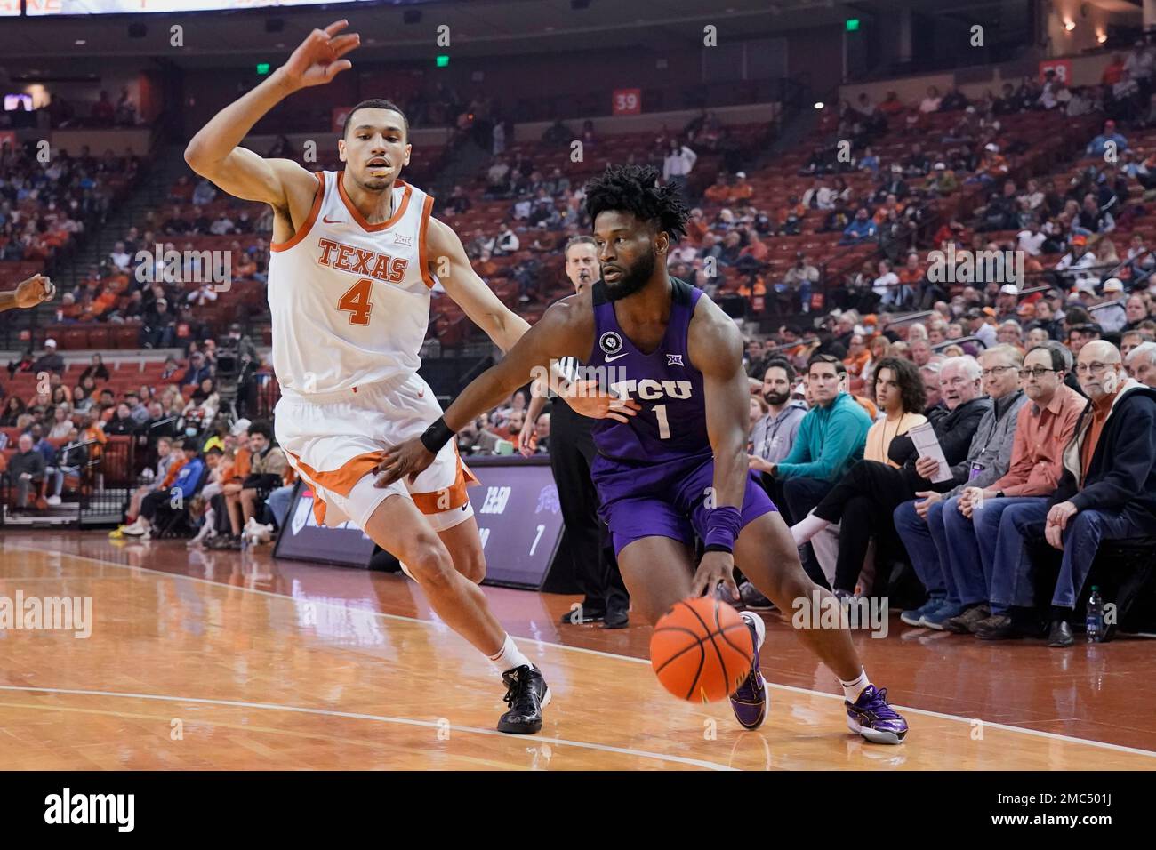 TCU guard Mike Miles (1) drives past Texas forward Dylan Disu (4 ...