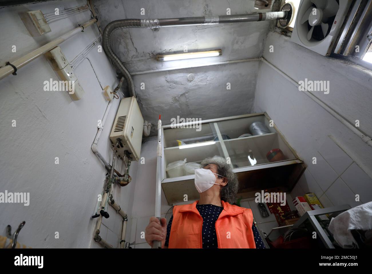 Public house resident Chan Tai-tai, 75 years old, points out one of the ...