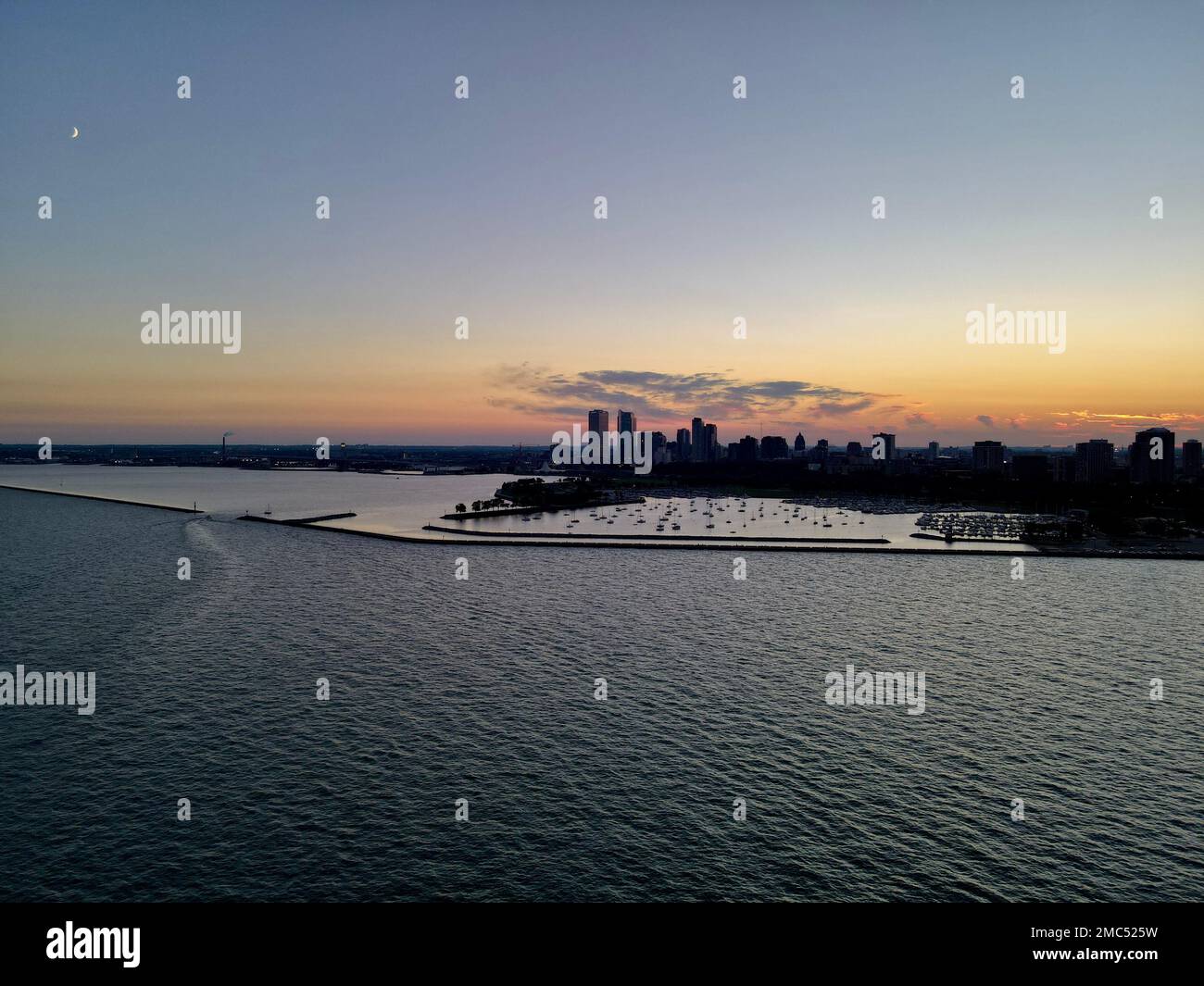 A drone over harbor with cityscape at seaside in Wisconsin at sunset ...