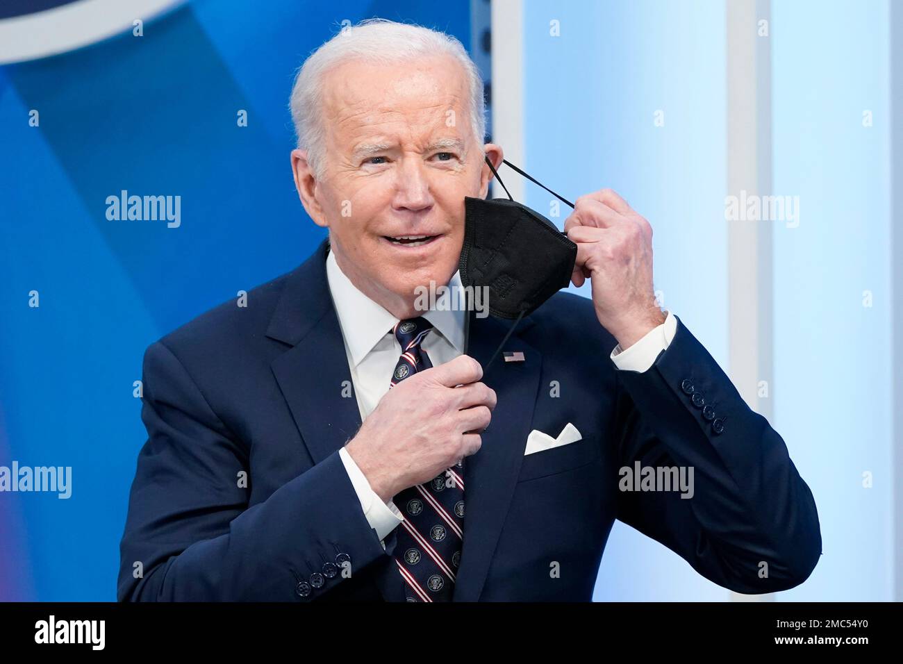 President Joe Biden removes his face mask to speak in the South Court ...