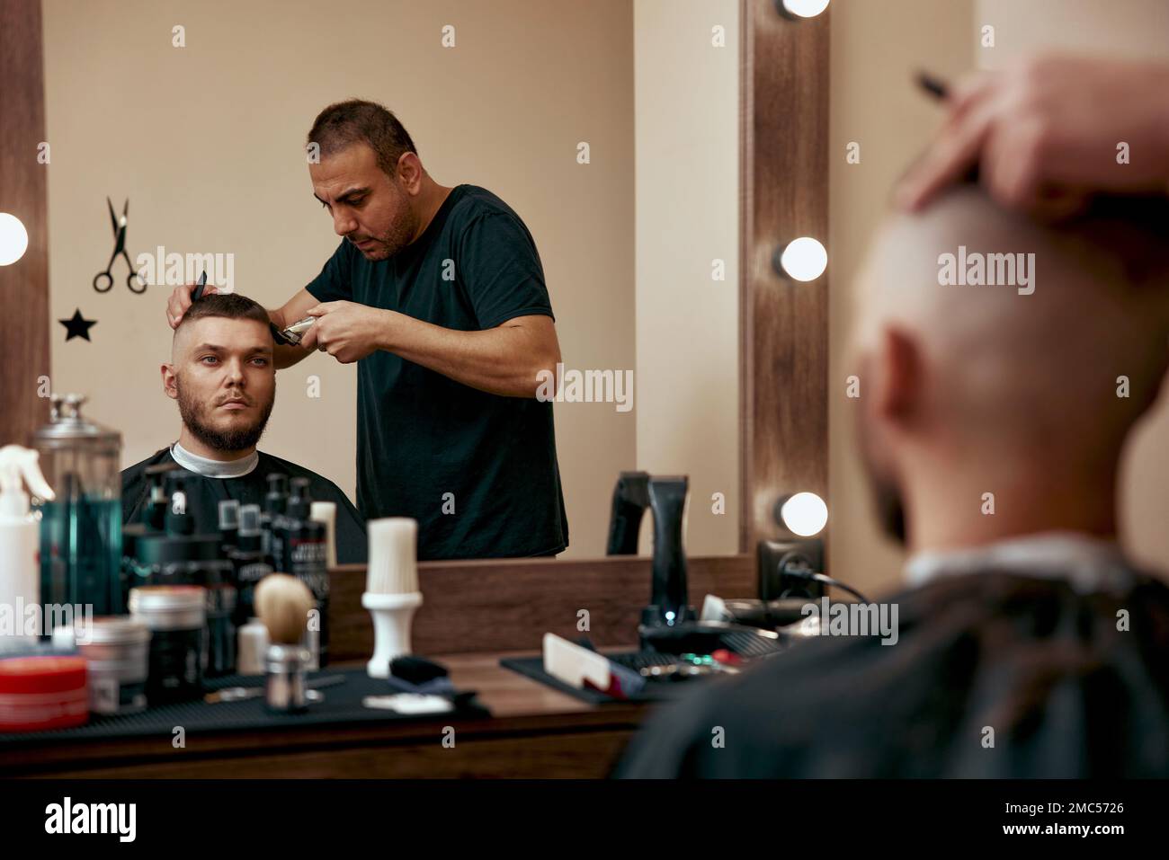 Barber shaving caucasian man in barber shop Stock Photo - Alamy