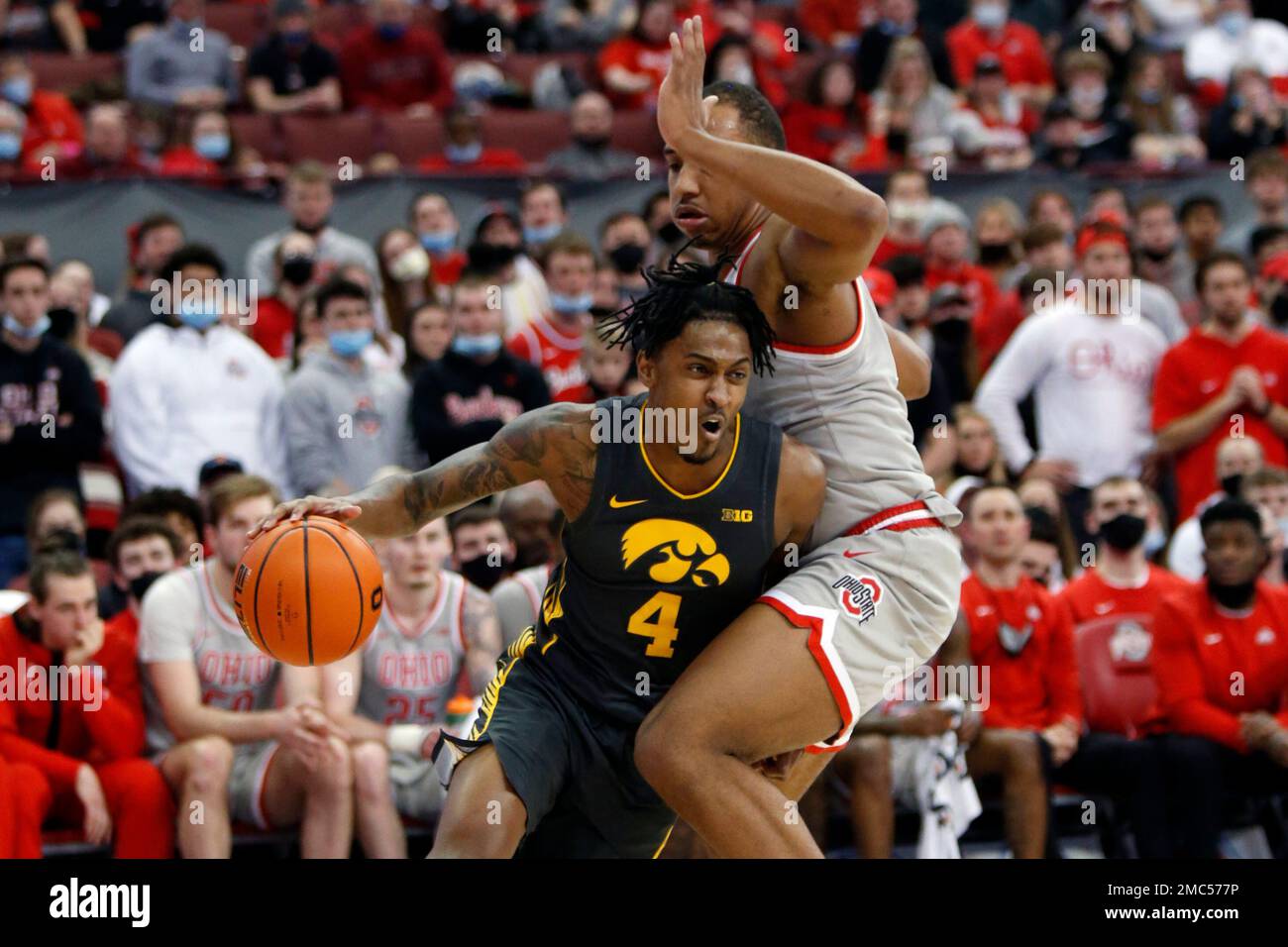 Iowa guard Ahron Ulis, left, drives against Ohio State forward Zed Key ...