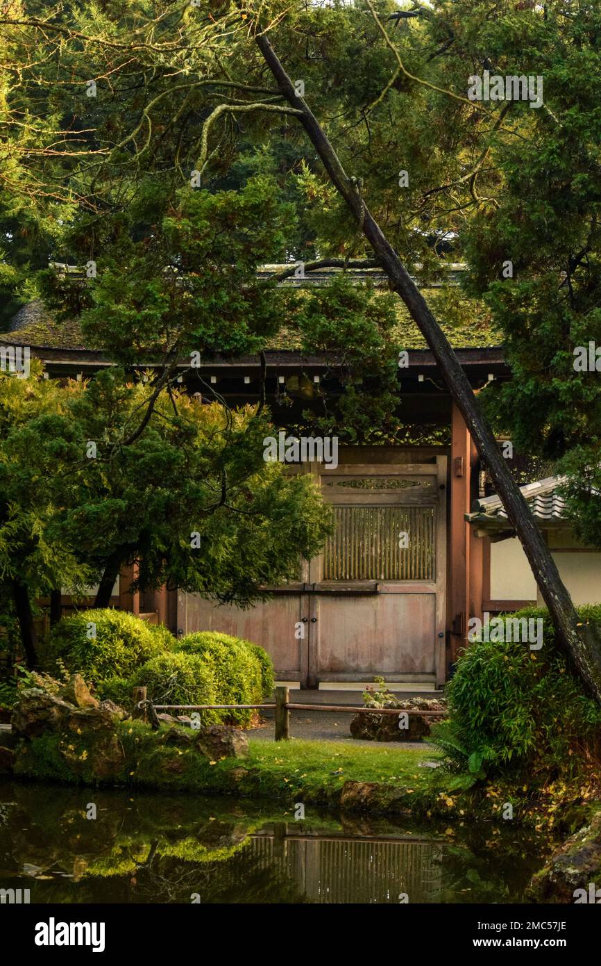 A vertical shot of the Japanese garden gates in front of the river ...