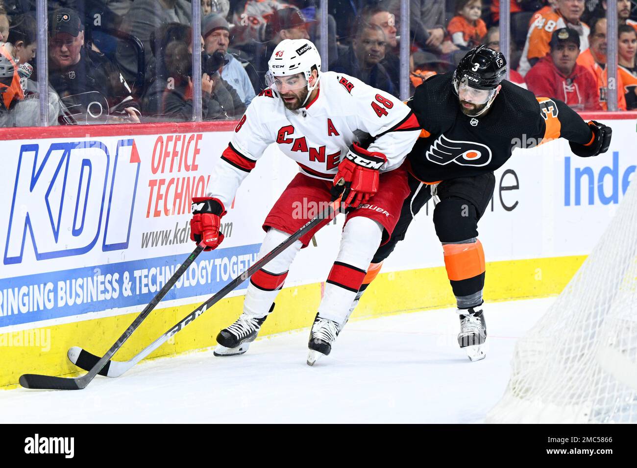 Carolina Hurricanes' Jordan Martinook, left, battles Philadelphia ...