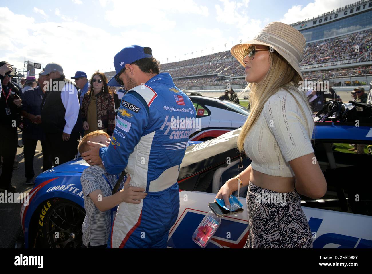 Driver Kyle Larson stands next to his car with his wife Katelyn and son ...