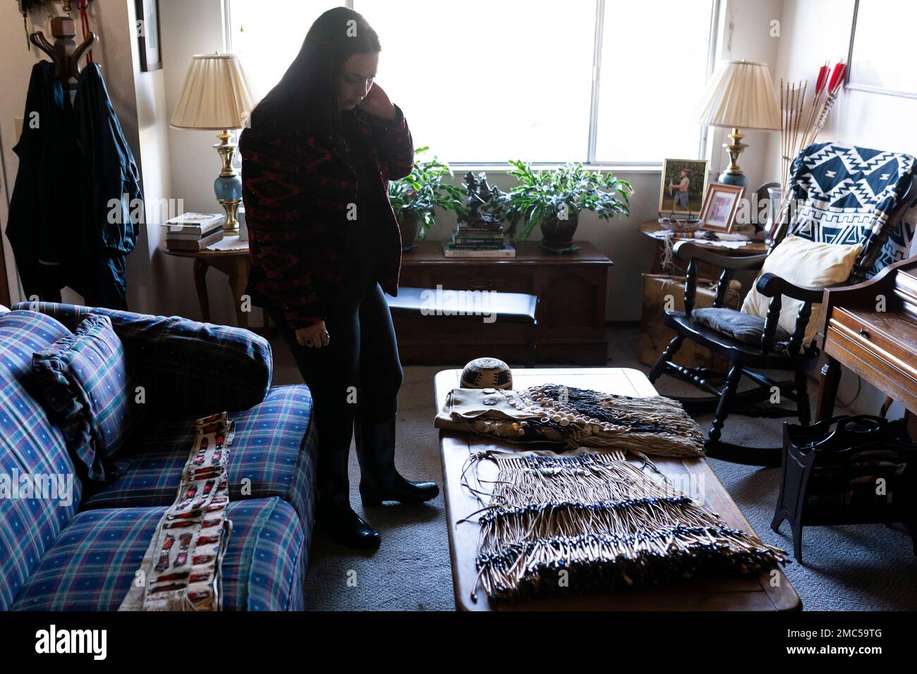 Mary Risling, 23, looks at dancing regalia that had been used by her ...