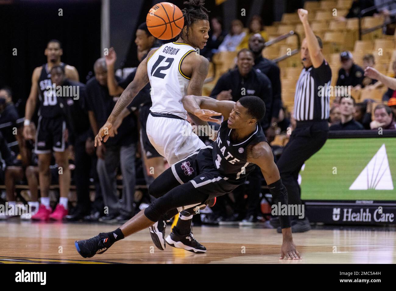 Mississippi State's Shakeel Moore, right, falls to the court after he ...