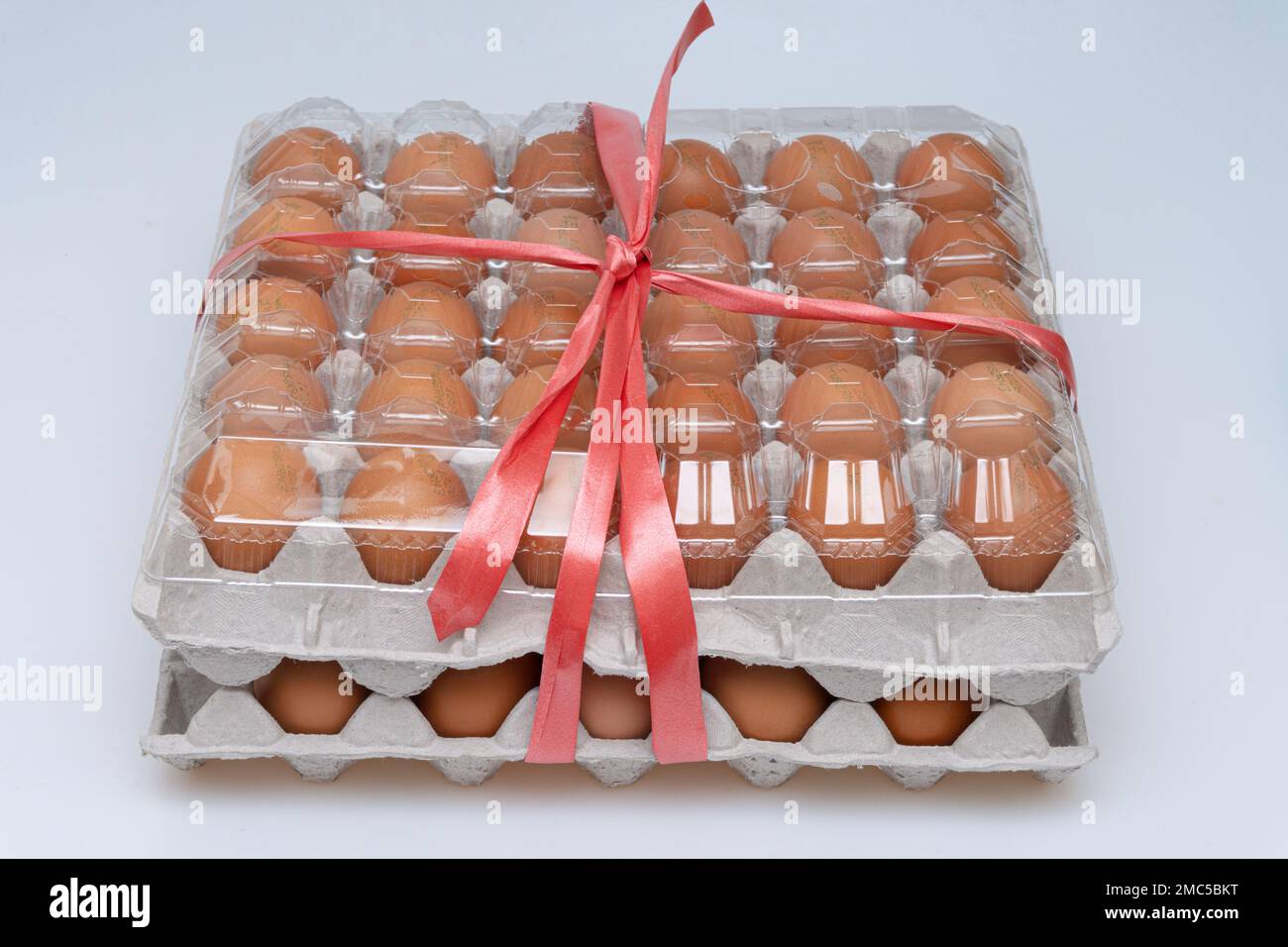 Bundle of 30 eggs tied with string Stock Photo - Alamy