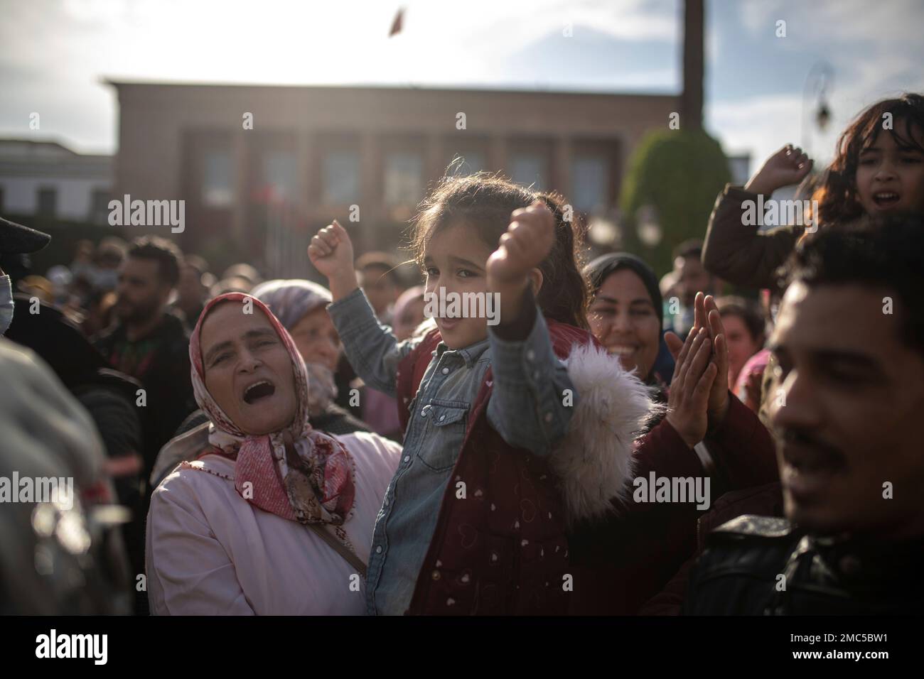 A child reacts as she is held by a family member during a protest ...