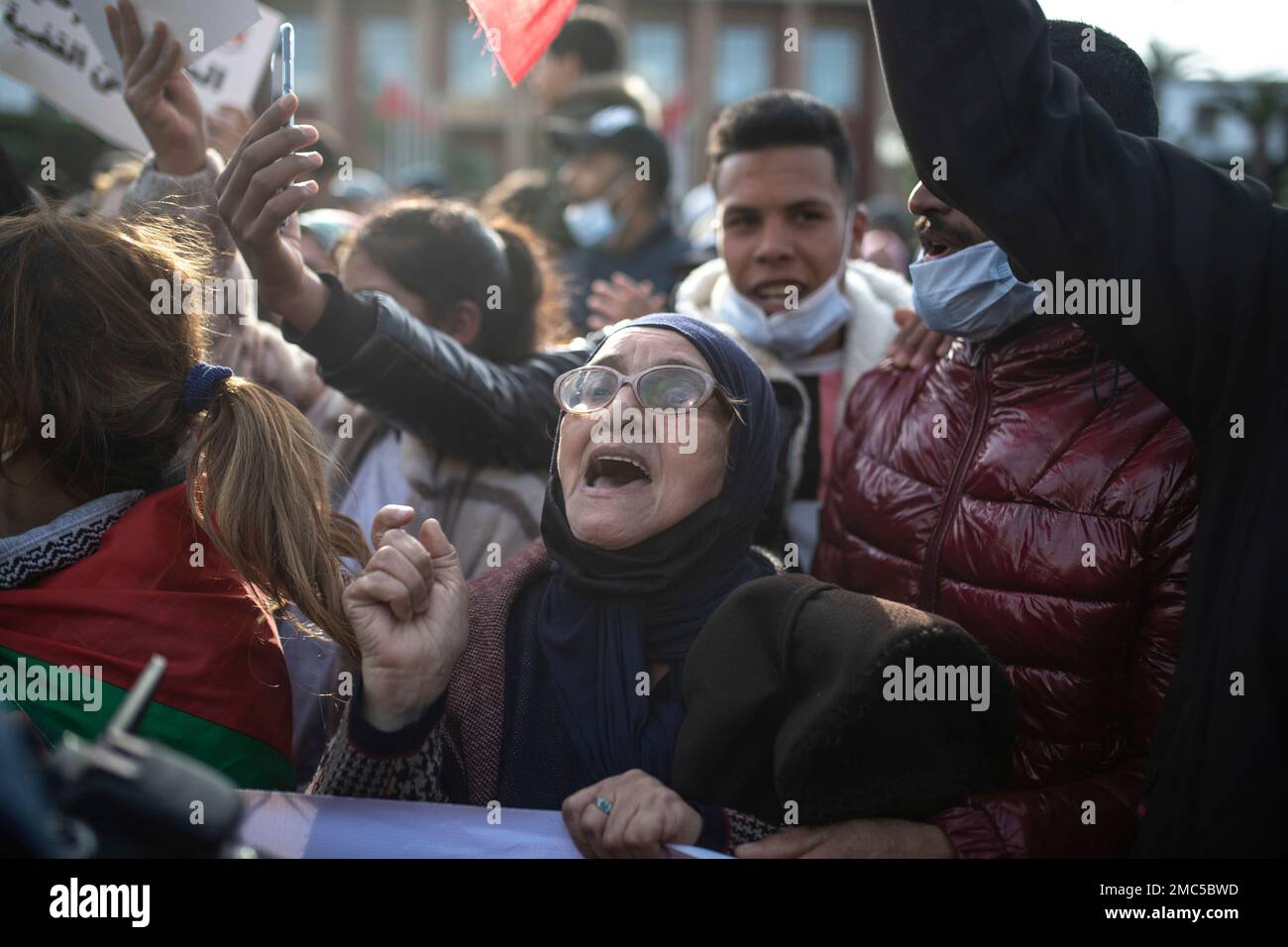 A woman chants slogans during a protest against price hikes and ...