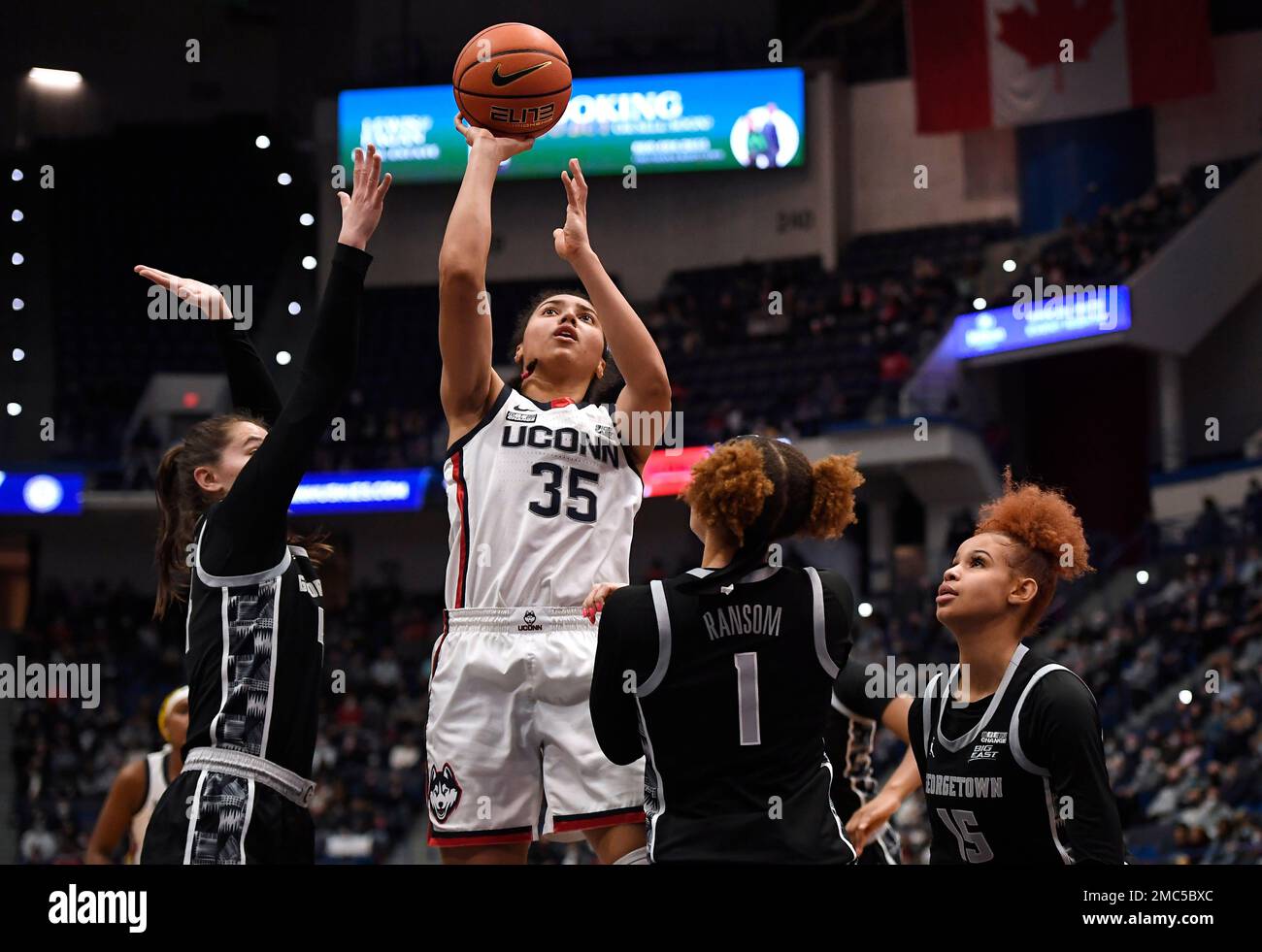 Connecticut's Azzi Fudd shoots over Georgetown's Mary Clougherty, left ...