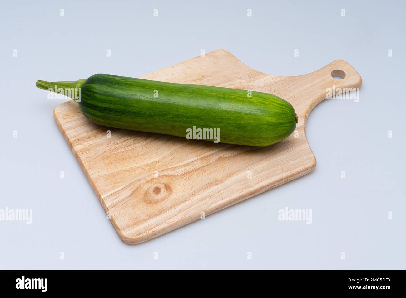 Fresh green(young)pumpkin on a white background Stock Photo - Alamy