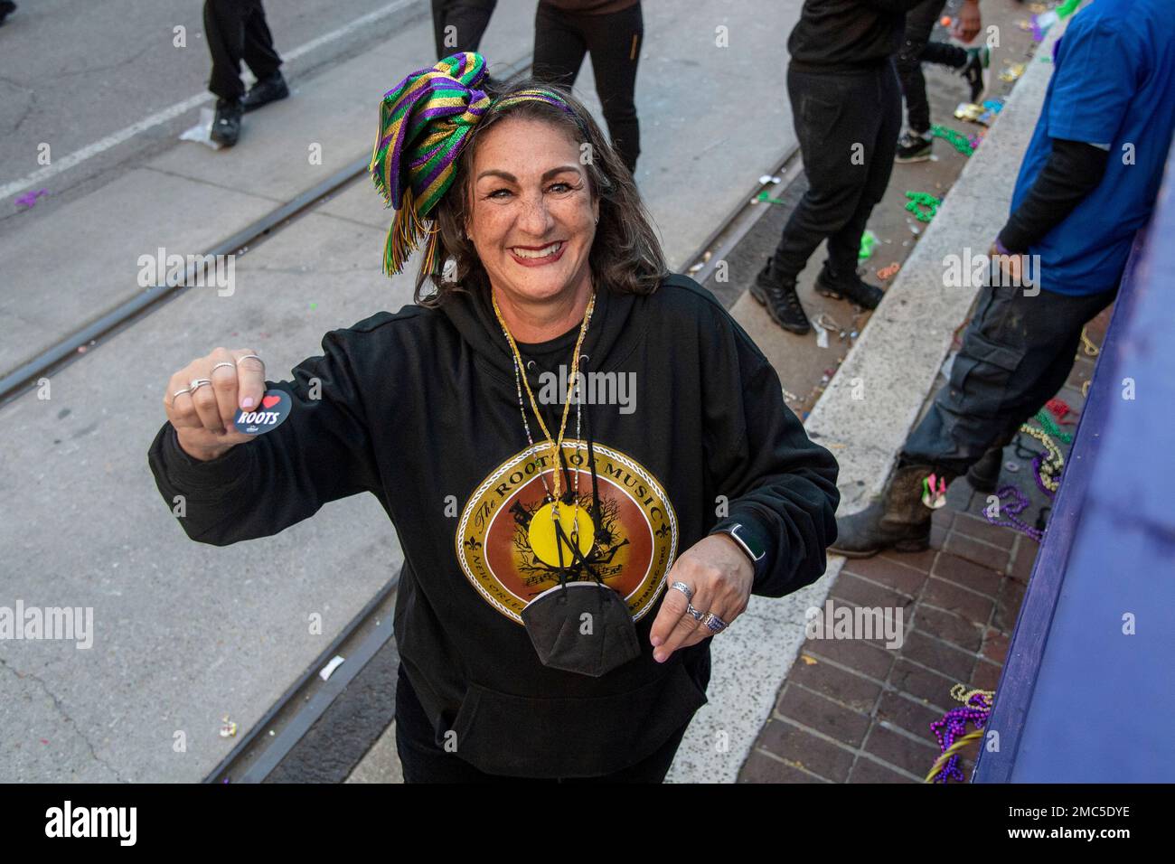 A reveler poses for a photo as the Krewe of Freret parade passes ...