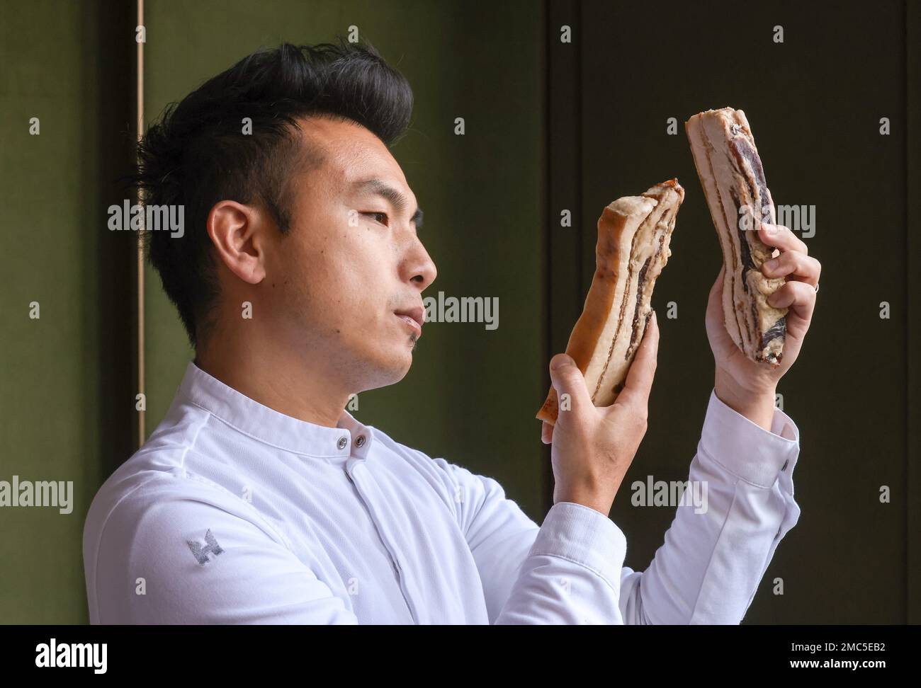 Chef Vicky Cheng Wing-ki inspecting his house preserved pork belly ...