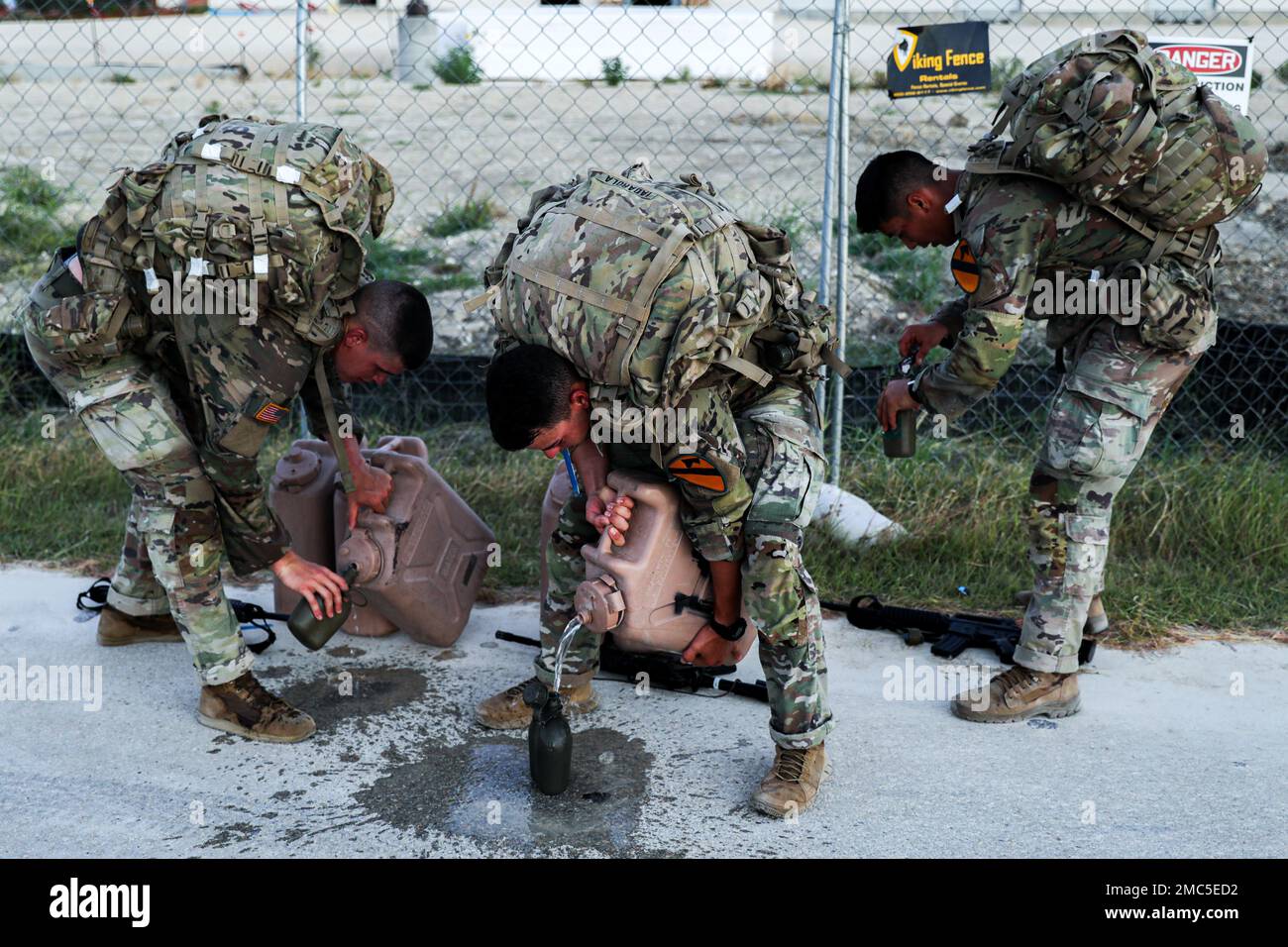 U.S. Army Soldiers assigned to 2-7 Cavalry 1st Cavalry Division refill water canteens to prevent ...