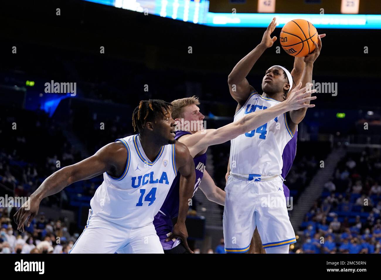 UCLA guard David Singleton, right, shoots against Washington during the ...