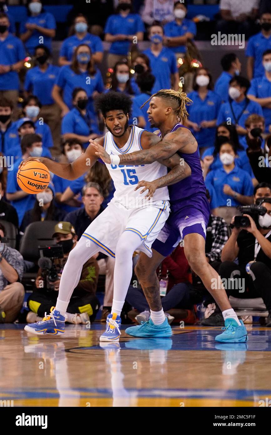 UCLA center Myles Johnson (15) is defended by Washington forward Nate ...
