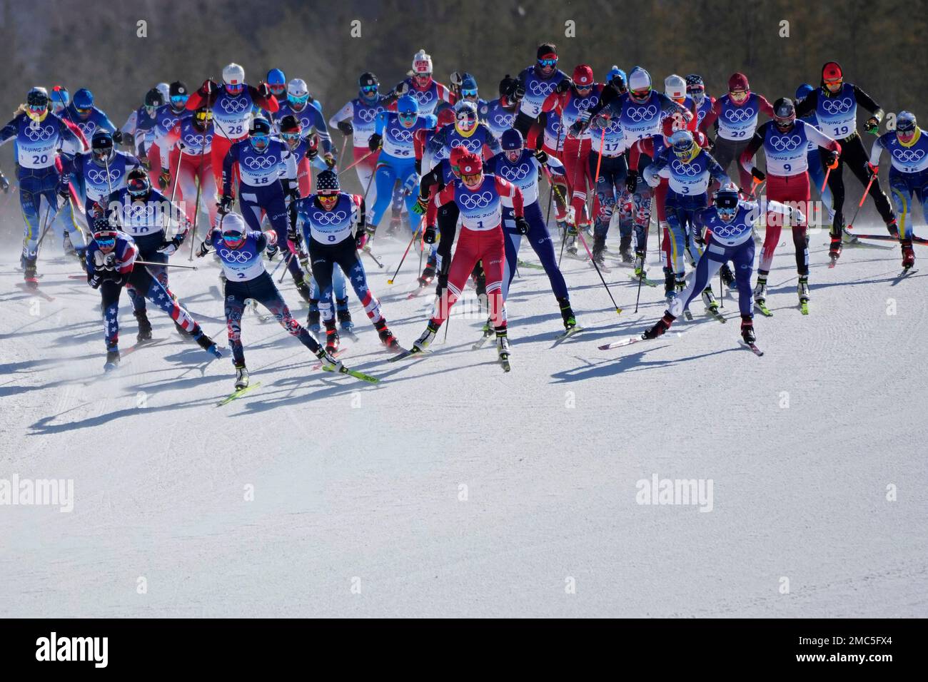 Skiers compete during the women's 30km mass start free cross-country ...