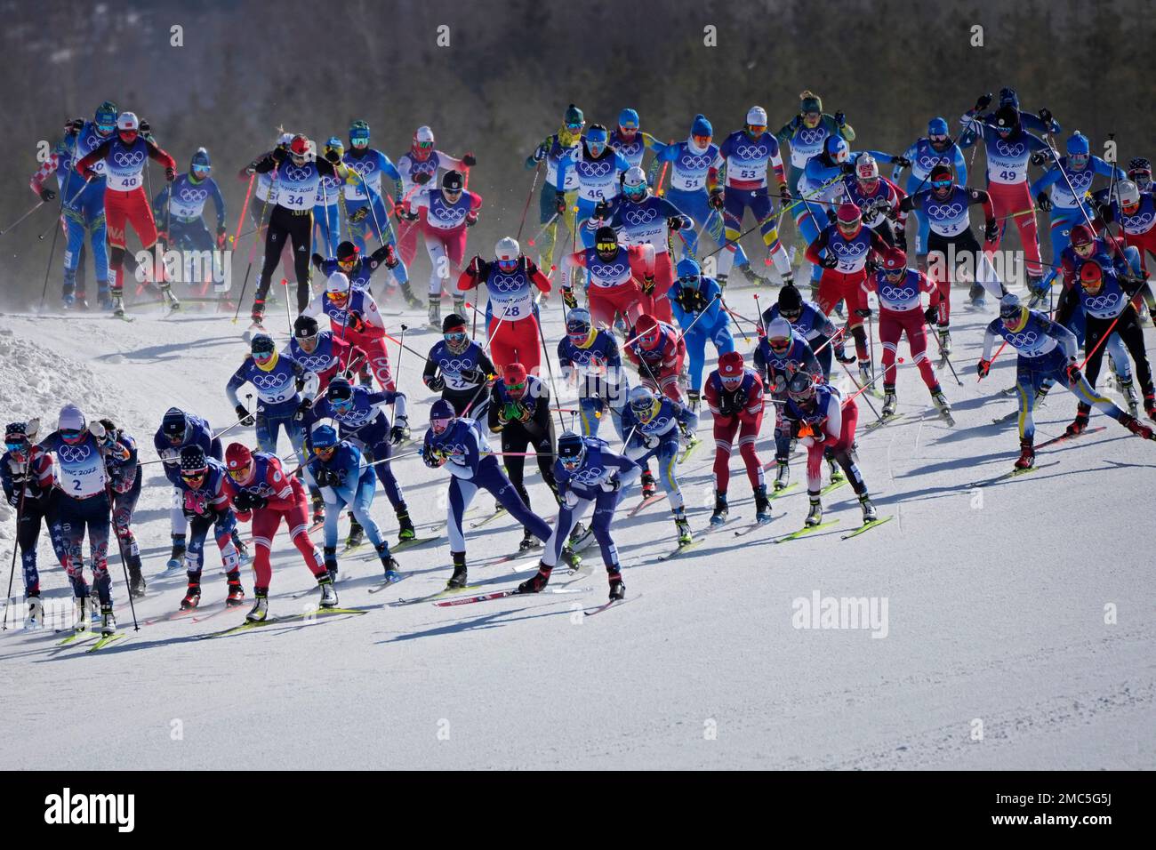 Skiers compete during the women's 30km mass start free cross-country ...