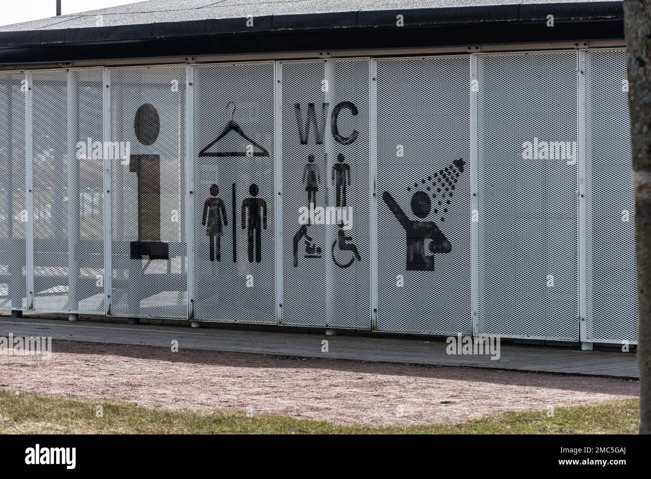 Signs on the side of a building wall marking dressing and shower ...