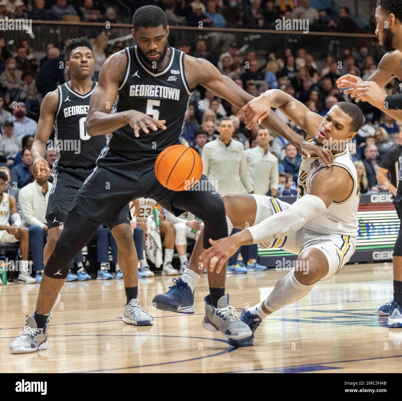 Georgetown center Timothy Ighoefe (5) and Villanova forward Eric Dixon ...