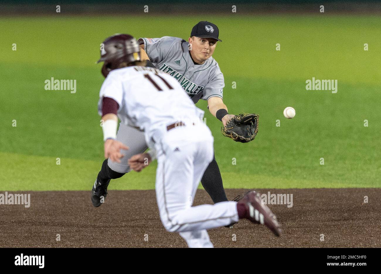 Utah Valley infielder Mick Madsen looks to field a grounder past Texas ...