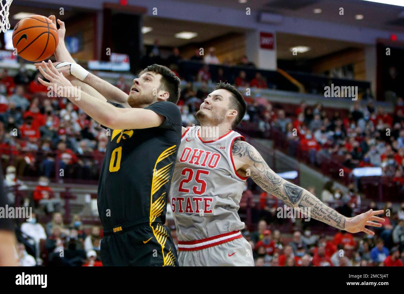 Ohio State forward Kyle Young (25) fouls Iowa forward Filip Rebraca ...