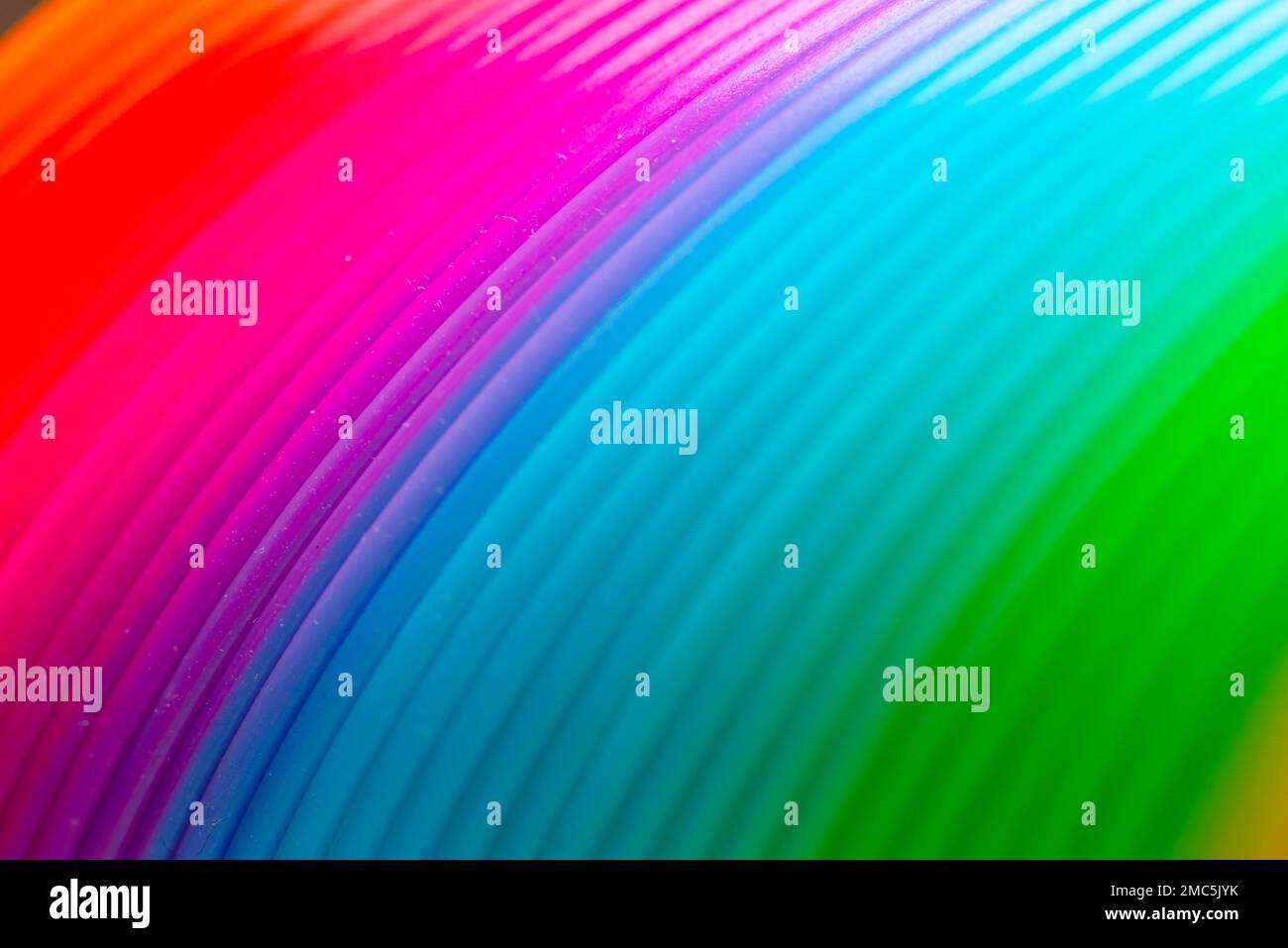 Details of a rainbow coloured plastic toy Stock Photo - Alamy