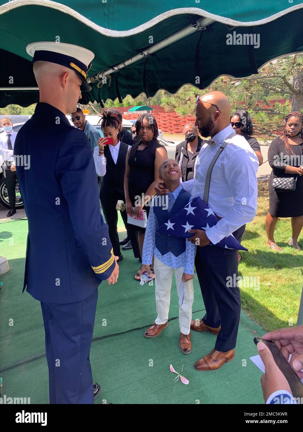 U.S. Coast Guard Lt. Cmdr. Zachary Ballard, USCGC Neah Bay, presents a ...