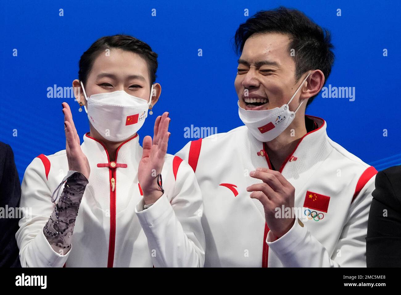 Peng Cheng and Jin Yang, of China, react after competing in the pairs ...