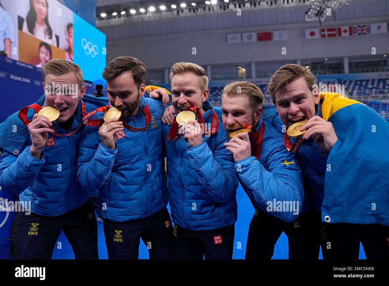 Gold medalists Team Sweden bite their medals during the medal ceremony ...