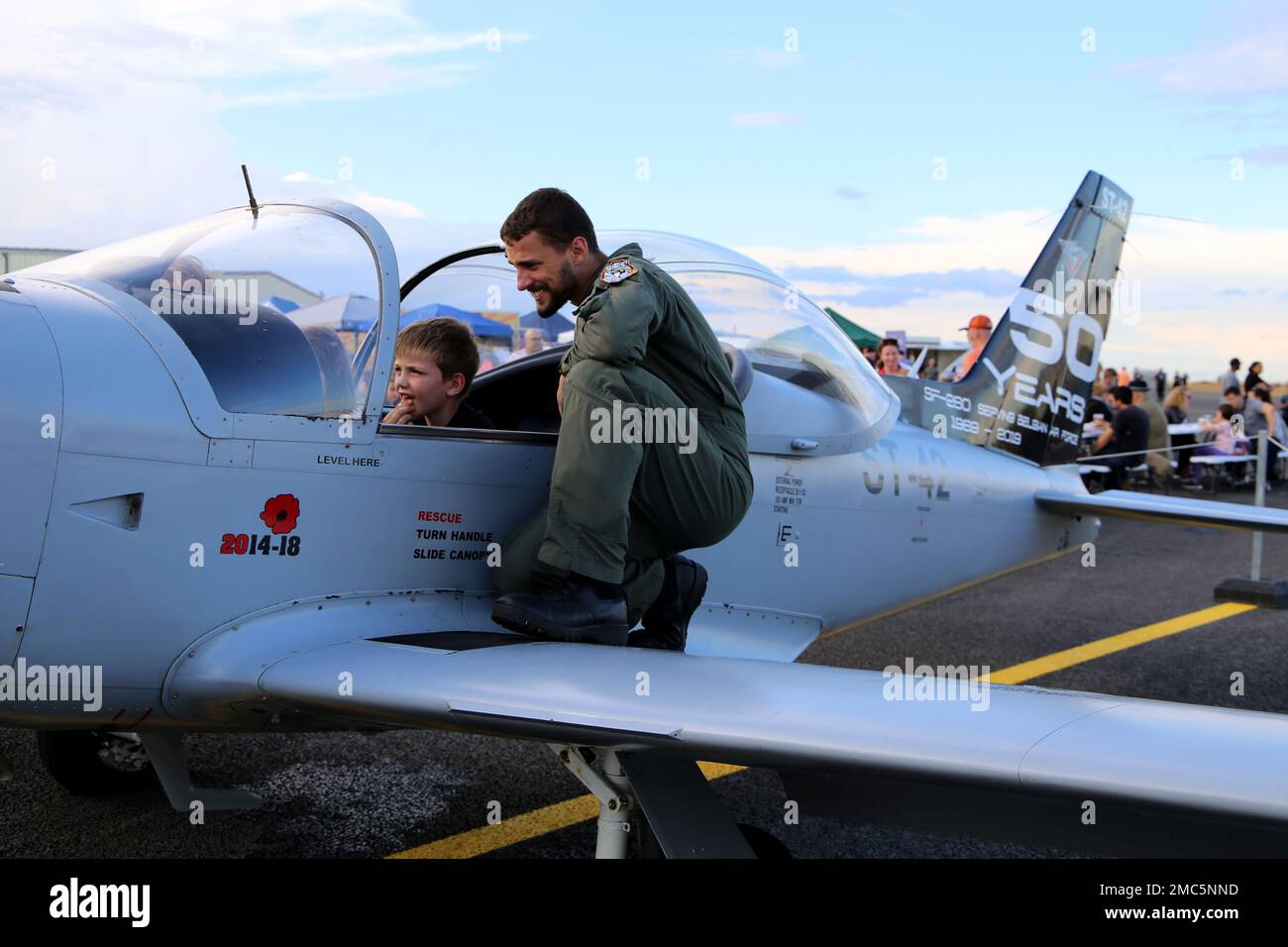 A child sits in the cockpit of a Belgian SF-260 Marchetti, a light ...