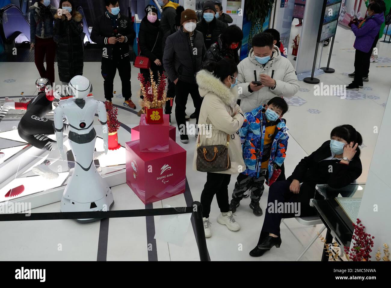 Shoppers line up at an official Olympics merchandise store as the 2022 ...