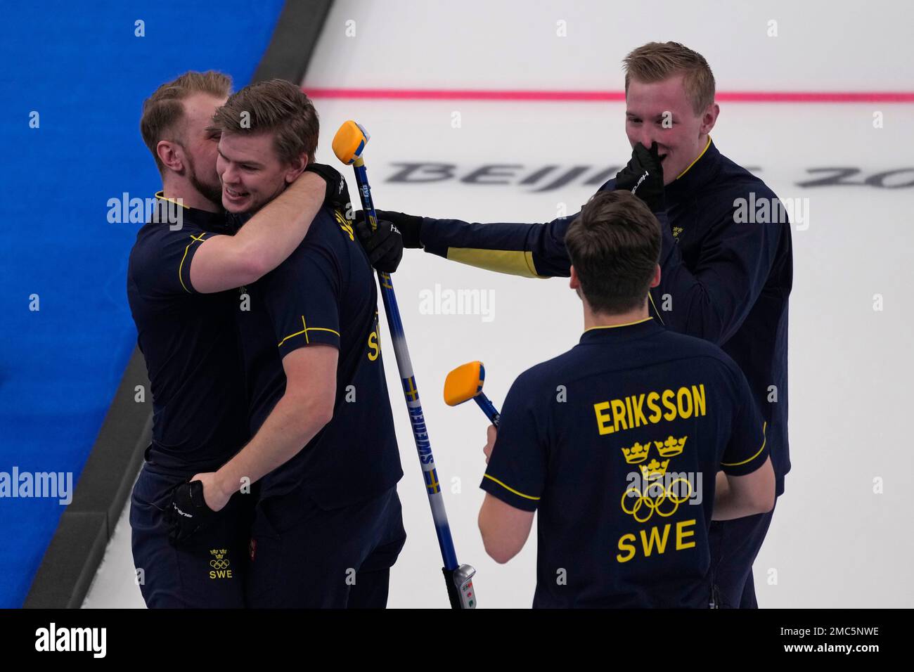 Team Sweden celebrates their win during the men's curling final match ...