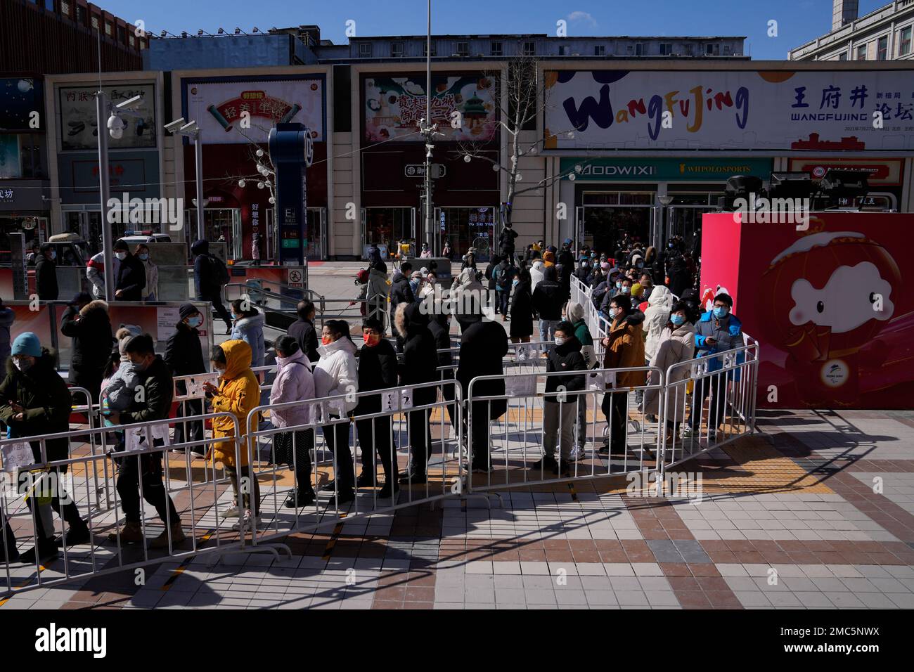 Residents continue to line up outside a store selling official Olympics ...