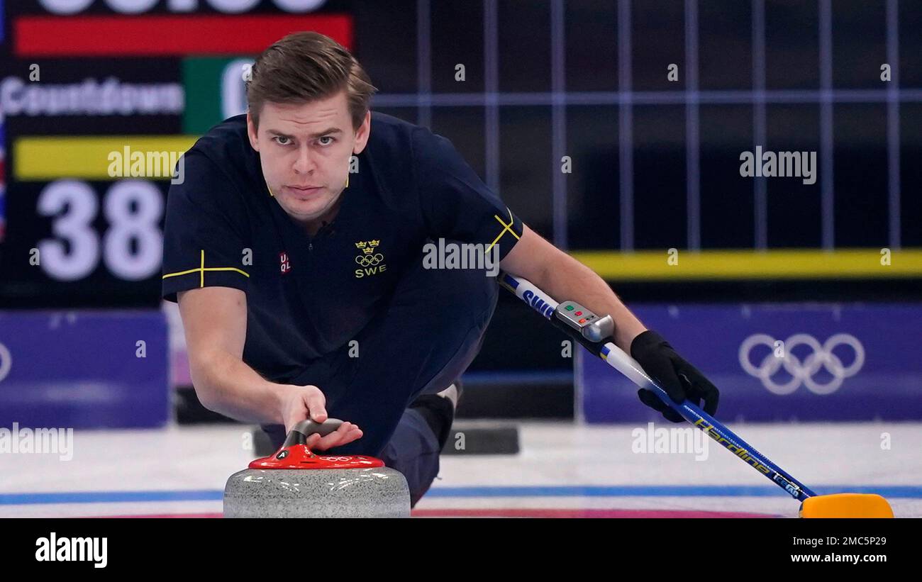 Sweden's Christoffer Sundgren throws a rock during the men's curling ...