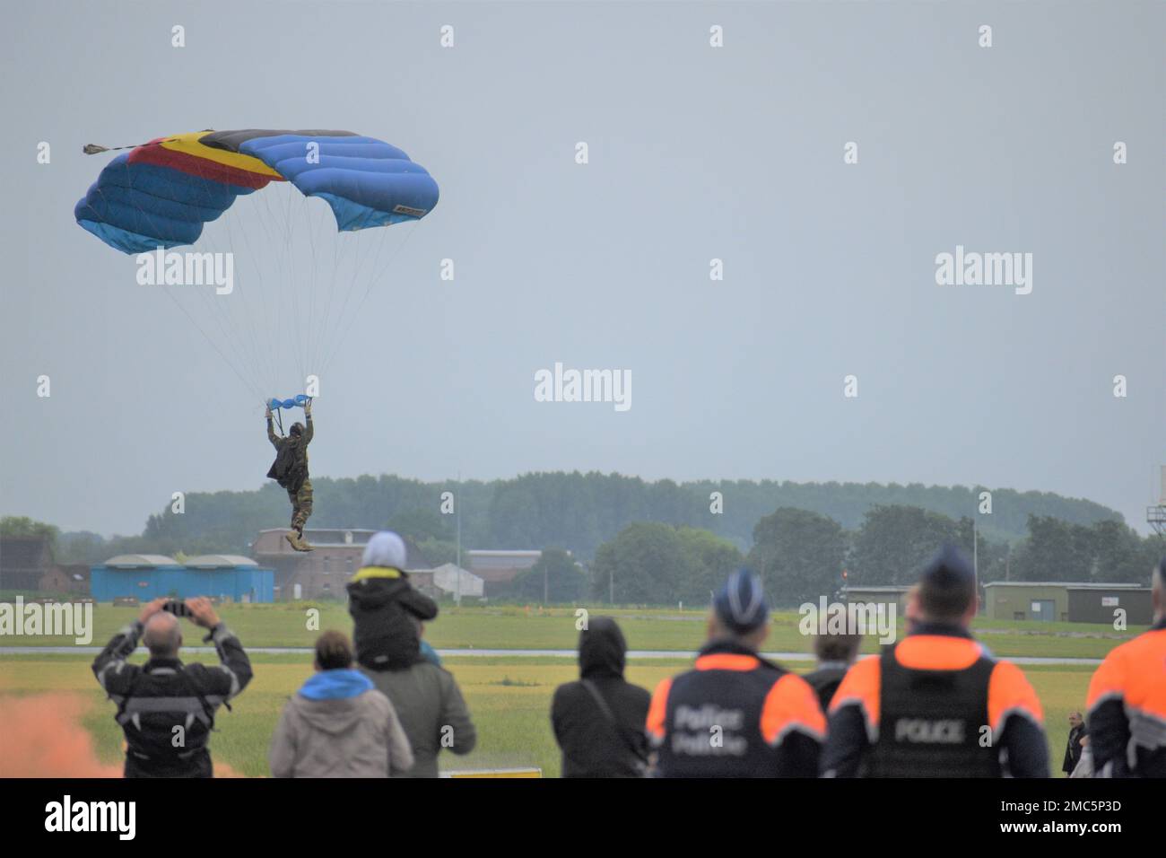 A Belgian paracommando lands on Chièvres Air Base, Belgium in front of ...