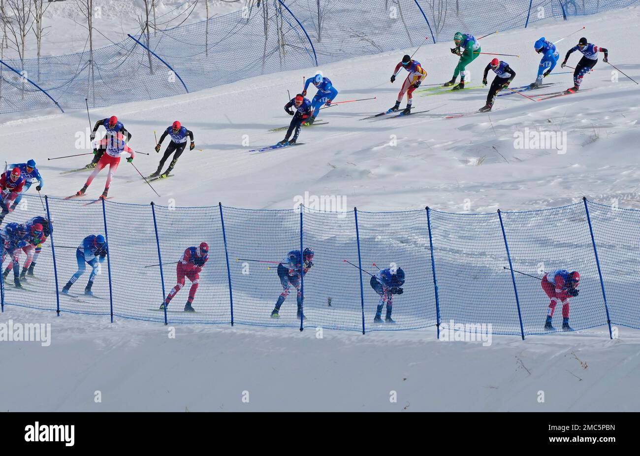 Skiers compete during the men's weather-shortened 50km mass start free ...