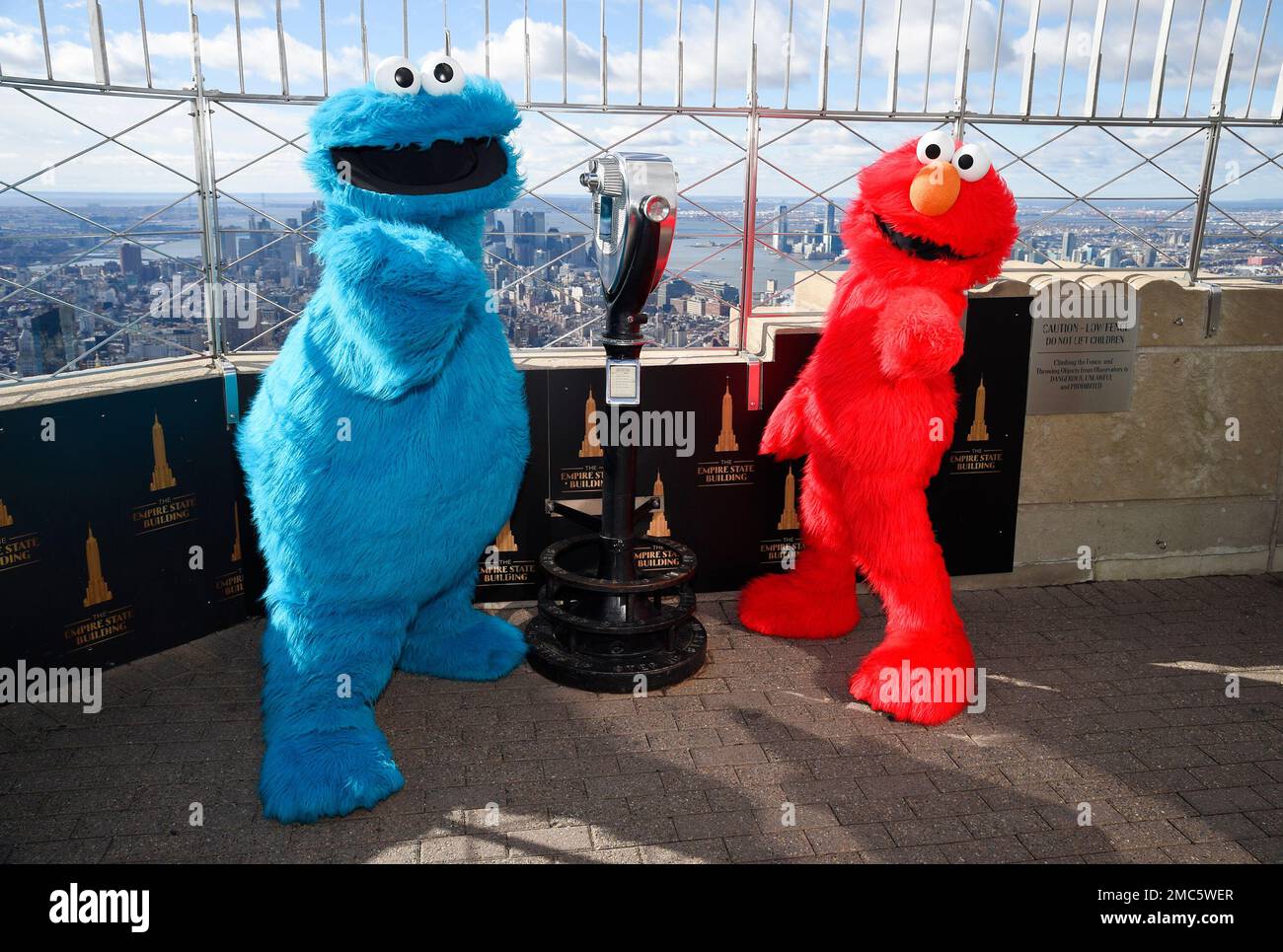 Sesame Street characters Cookie Monster, left, and Elmo pose on the ...