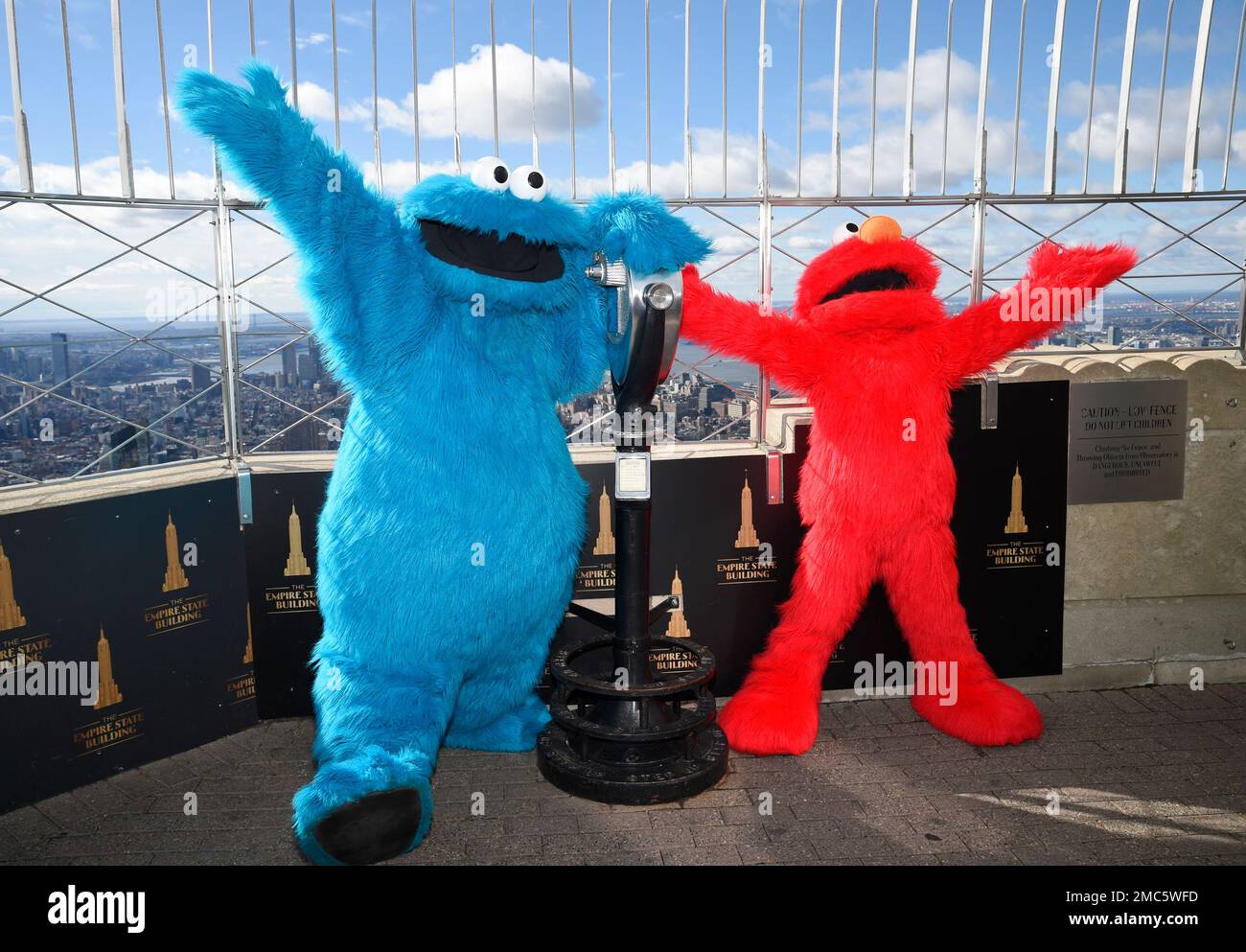 Sesame Street characters Cookie Monster, left, and Elmo pose on the ...