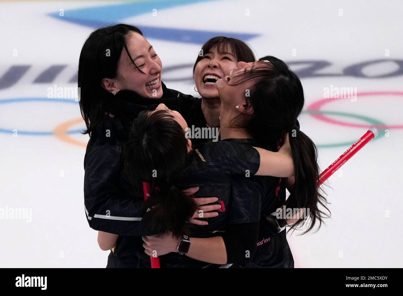 Japan's athletes celebrate after winning the women's curling semifinal ...
