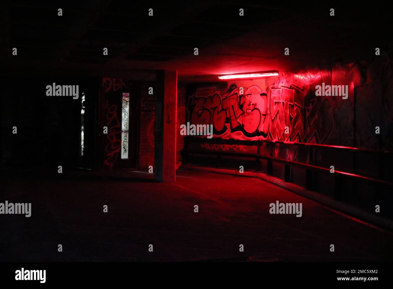 An underground urban and dark room with a red light Stock Photo - Alamy