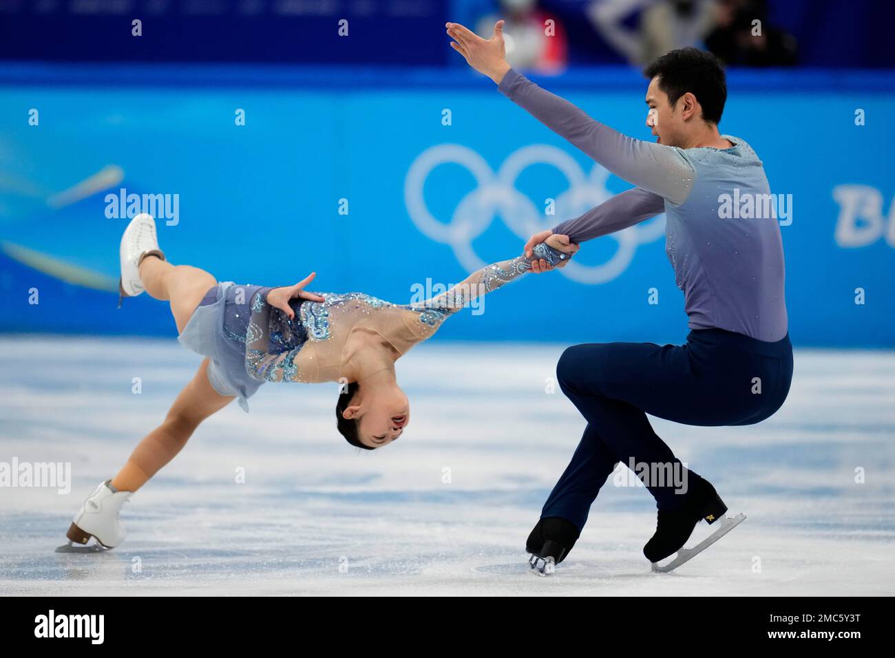 Peng Cheng and Jin Yang, of China, compete in the pairs short program ...