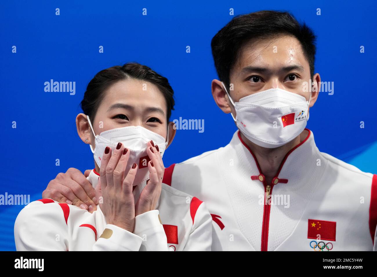 Peng Cheng and Jin Yang, of China, react after the pairs short program ...