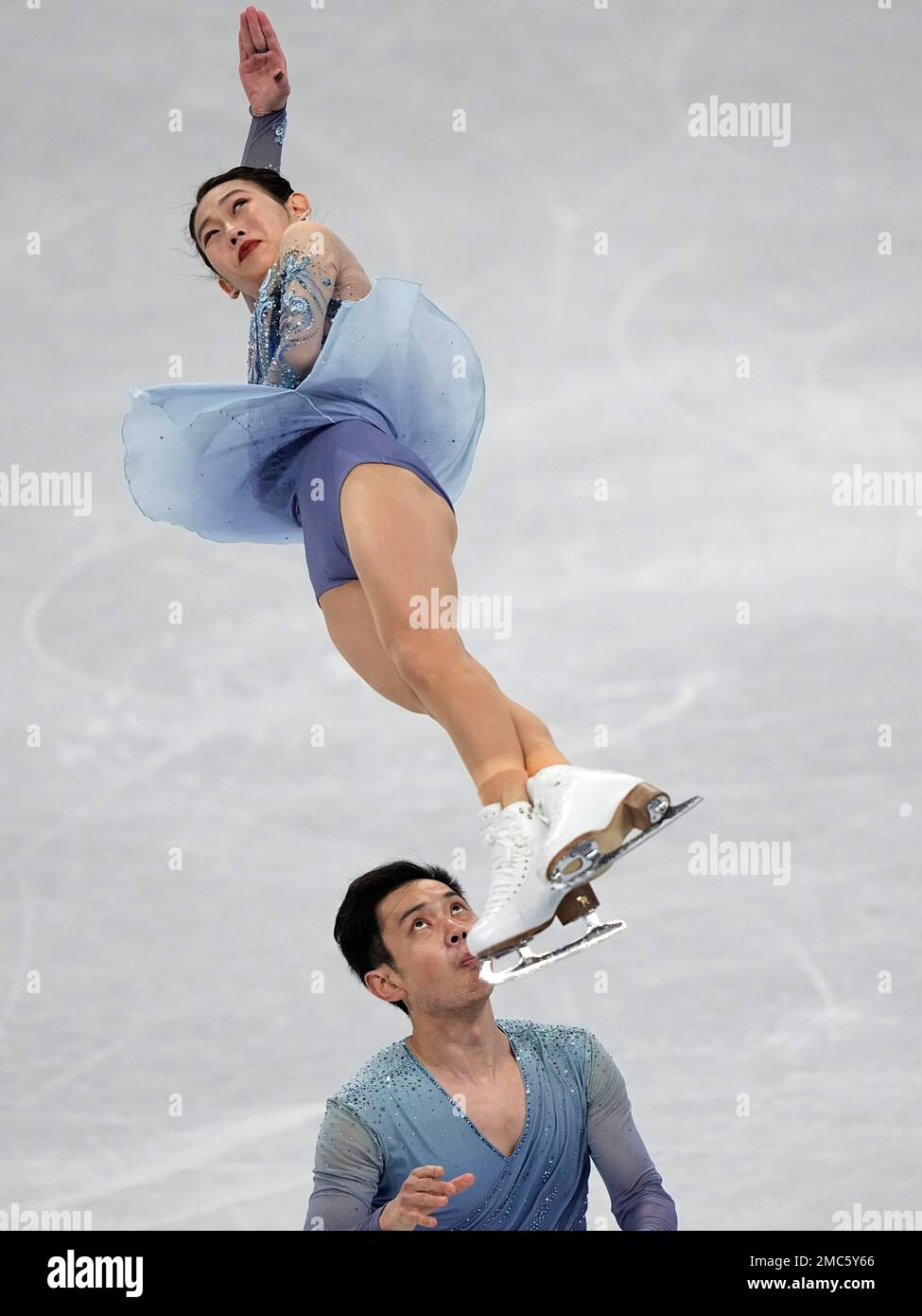 Peng Cheng and Jin Yang, of China, compete in the pairs short program ...