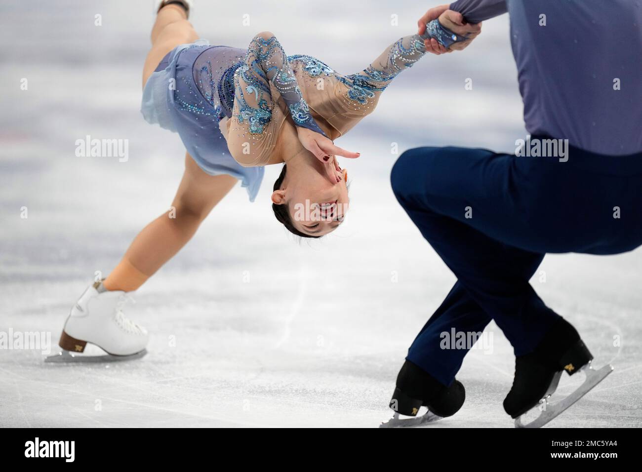 Peng Cheng and Jin Yang, of China, compete in the pairs short program ...