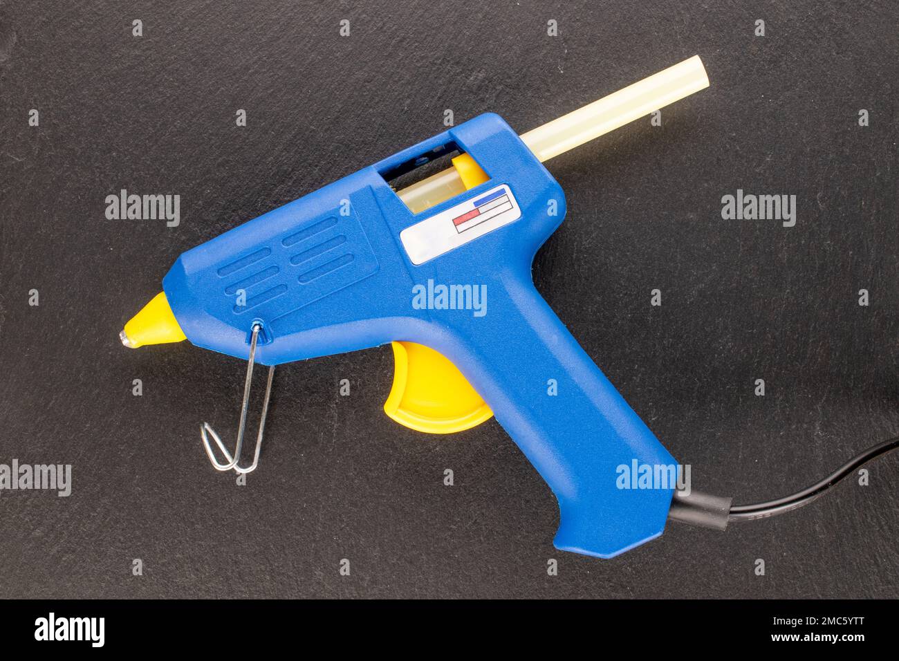 One electric glue gun on slate stone, macro, top view Stock Photo - Alamy
