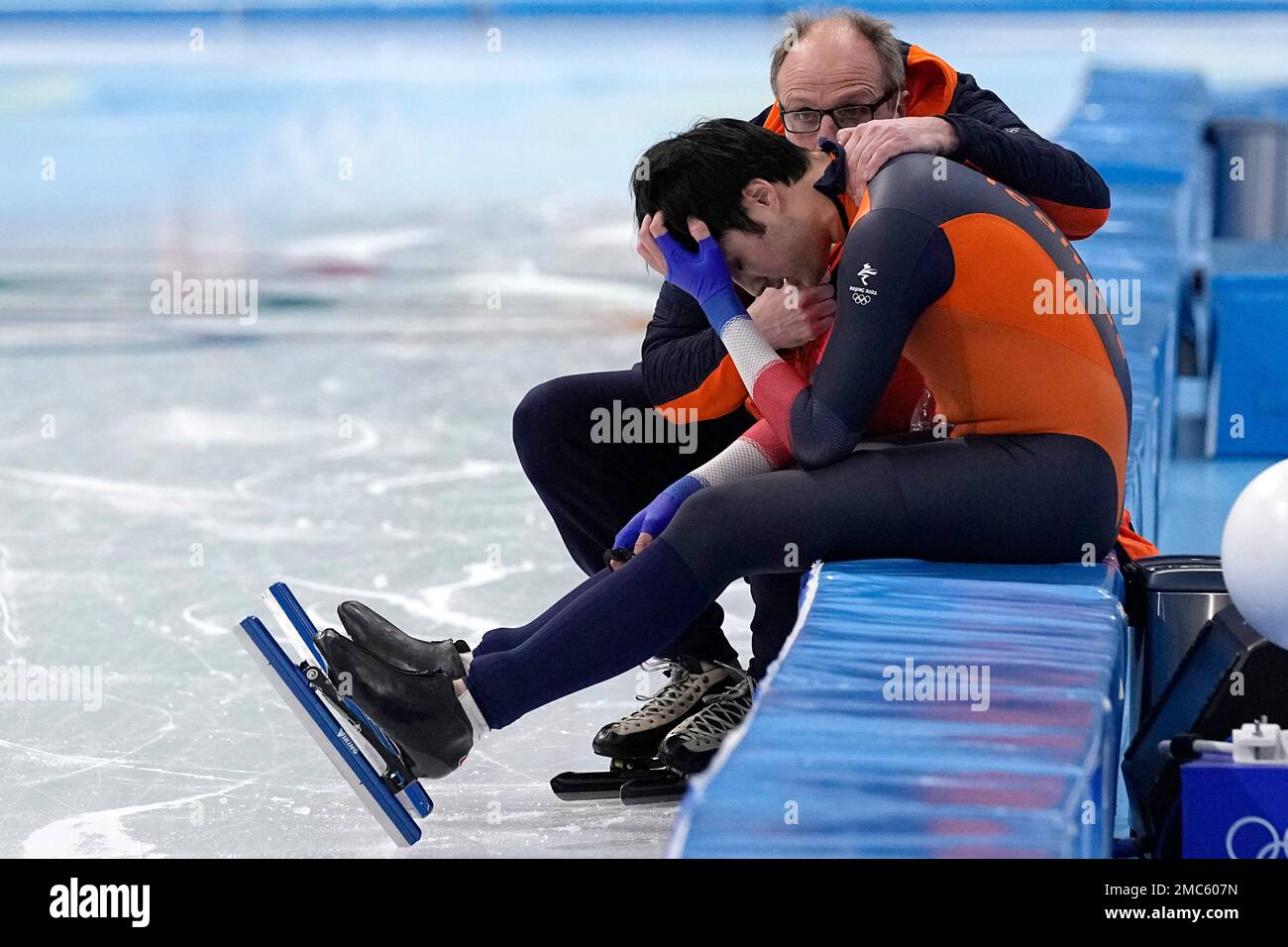 Kai Verbij of the Netherlands is comforted by coach Jac Orie after his ...